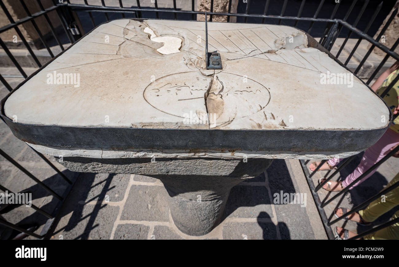 View of old ancient stone sundial in courtyard of Ulu (Grand) Mosque in ...