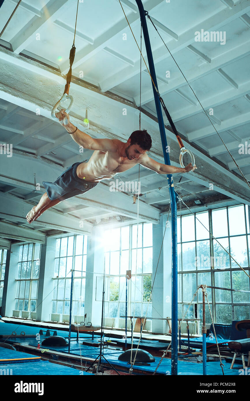 The sportsman during difficult exercise, sports gymnastics Stock Photo ...