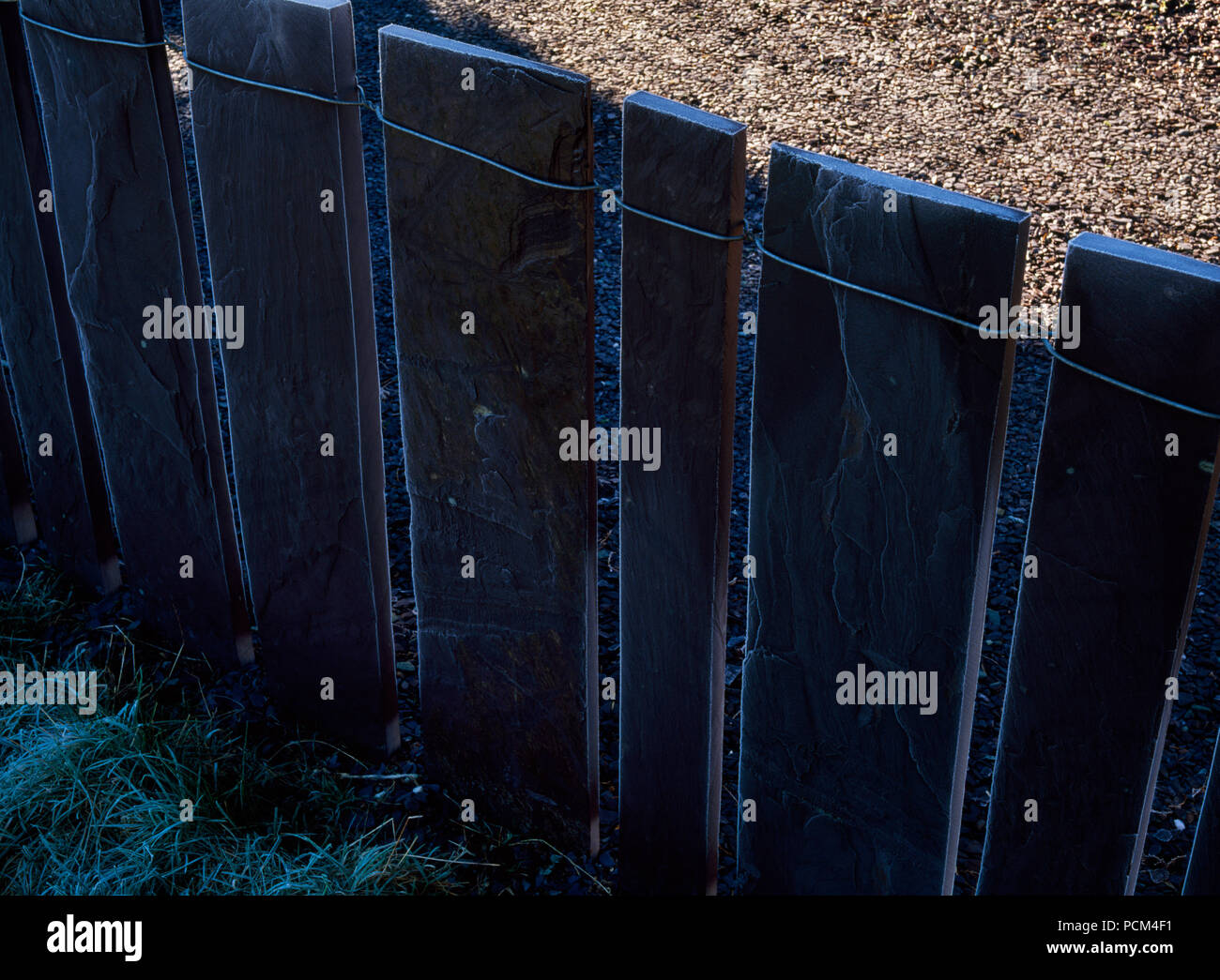 Detail of a modern slate fence of heather blue slabs from Penrhyn ...