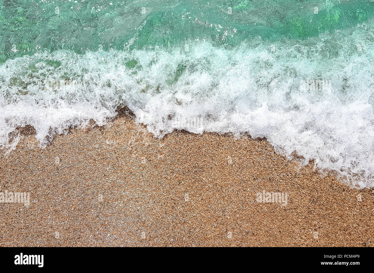 Ocean wave on sandy beach Stock Photo - Alamy