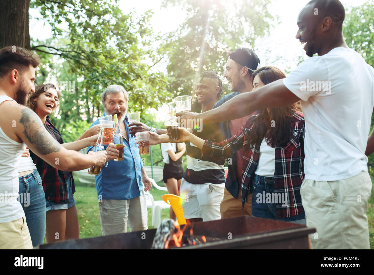 Group of friends making barbecue in the backyard. concept about good ...