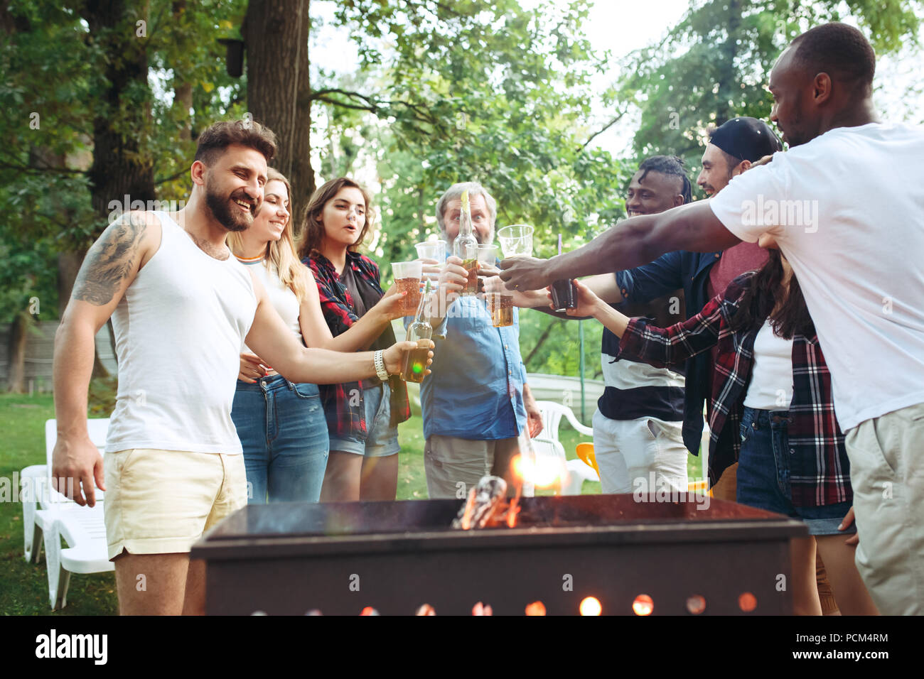 Group of friends making barbecue in the backyard. concept about good ...