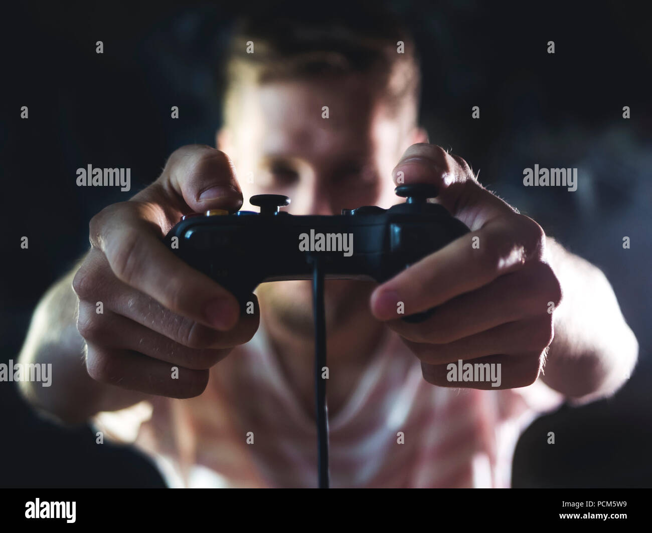 bearded man holding video game joystick controller in hands in front of ...