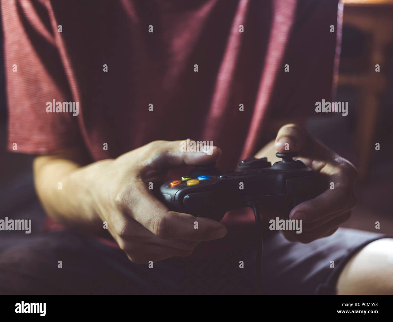 bearded man holding video game joystick controller in hands in front of ...