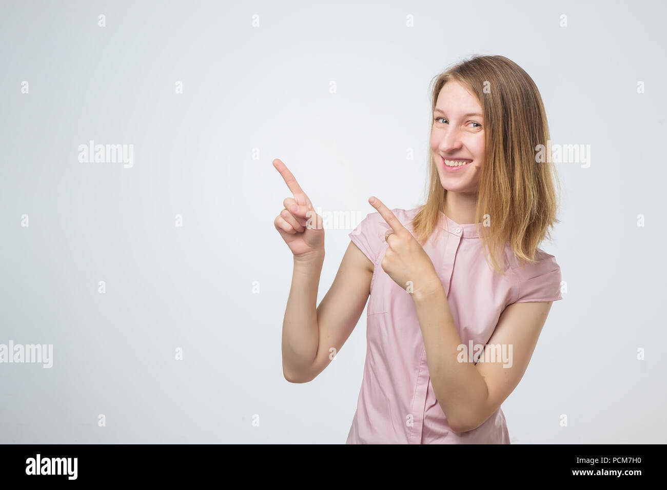 Pretty girl showing direction isolated hi-res stock photography and ...