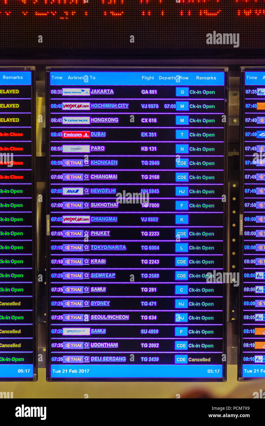 Passengers looking at display board information inside hi-res stock ...