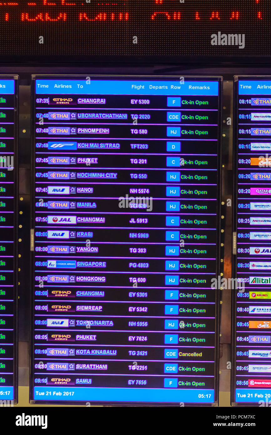 Passengers looking at display board information inside hi-res stock ...