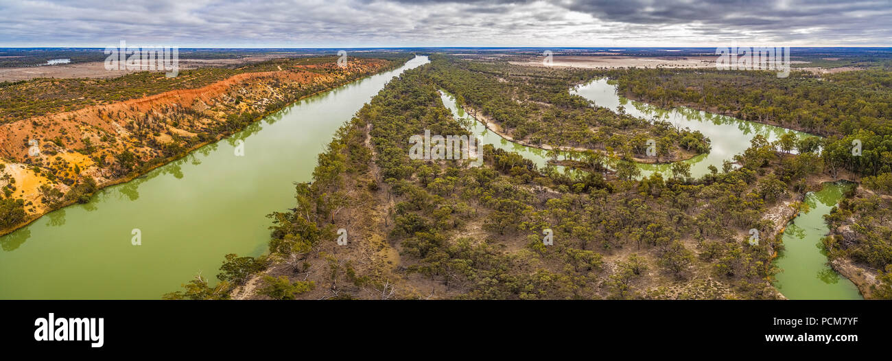 Wide aerial panorama of eroding sandstone cliffs over meandering Murray ...