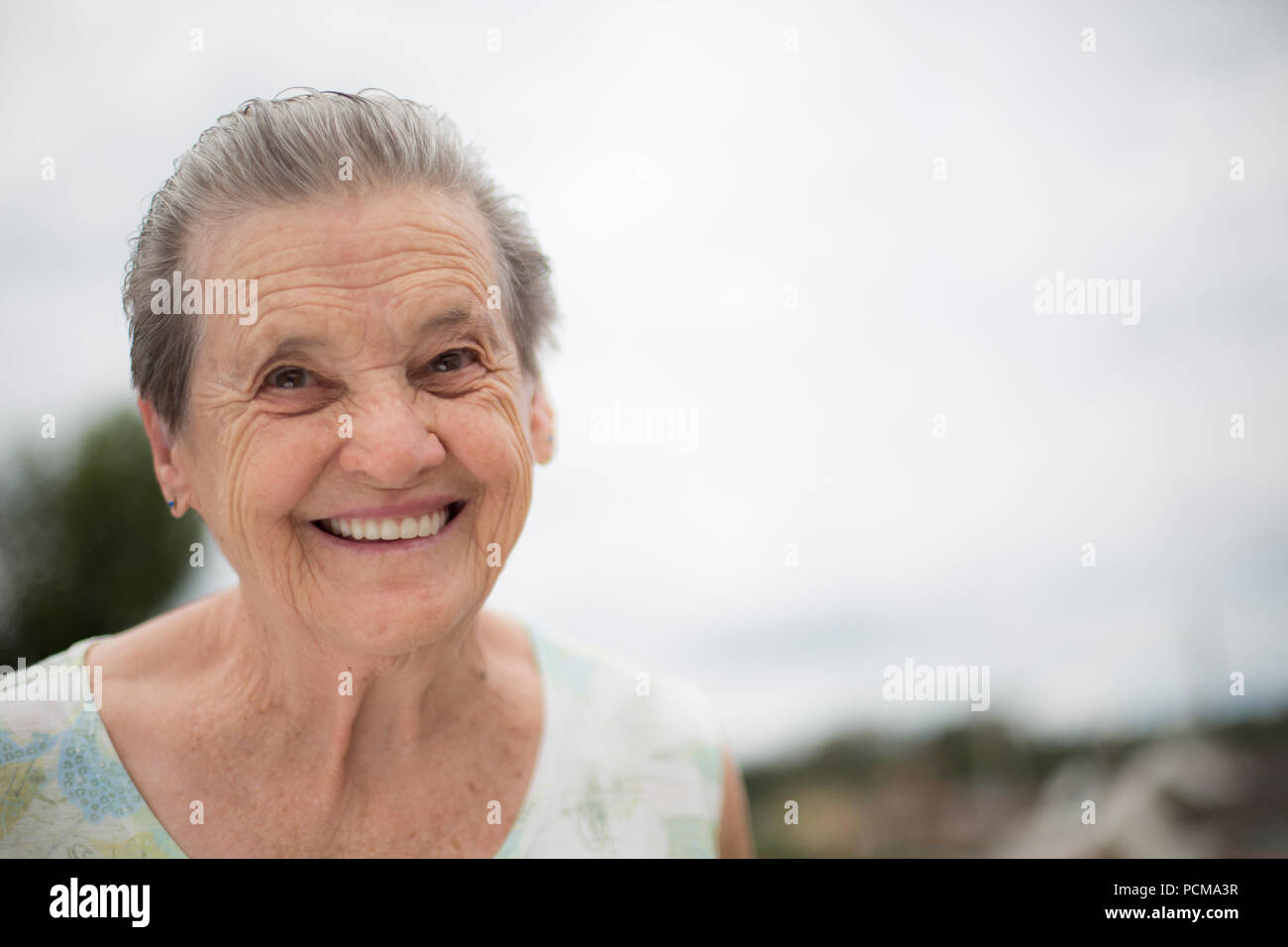 Happy older lady standing hi-res stock photography and images - Alamy
