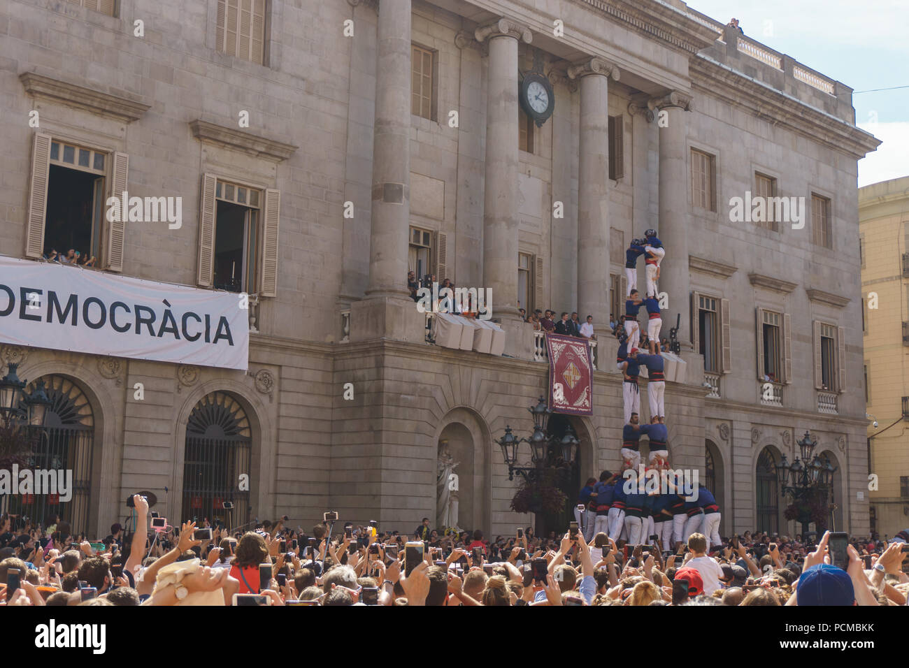 people building a human pyramid during the festival in catalunya, spain ...