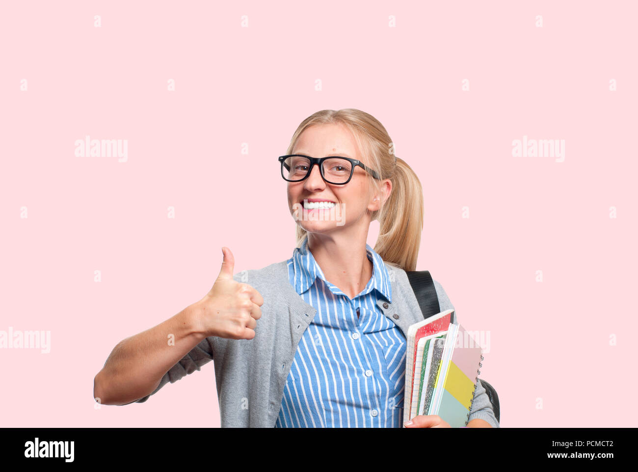 Happy young student girl holding books, high school or college graduand ...