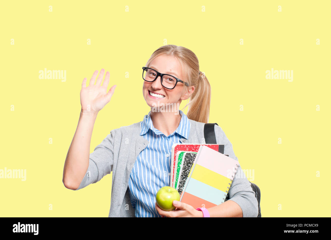 Happy young student girl holding books, high school or college graduand ...