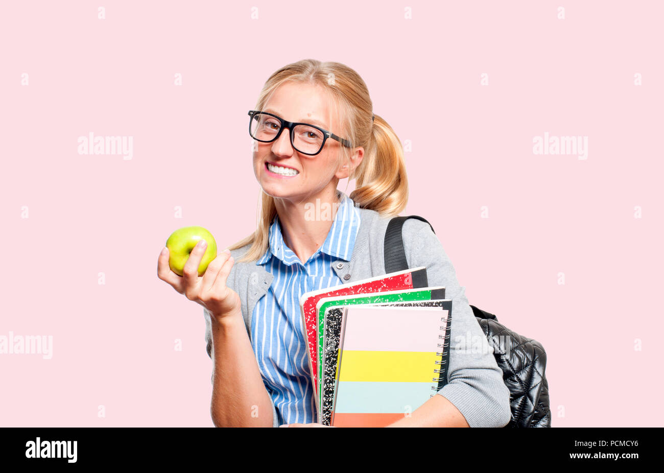 Happy young student girl holding books, high school or college graduand ...