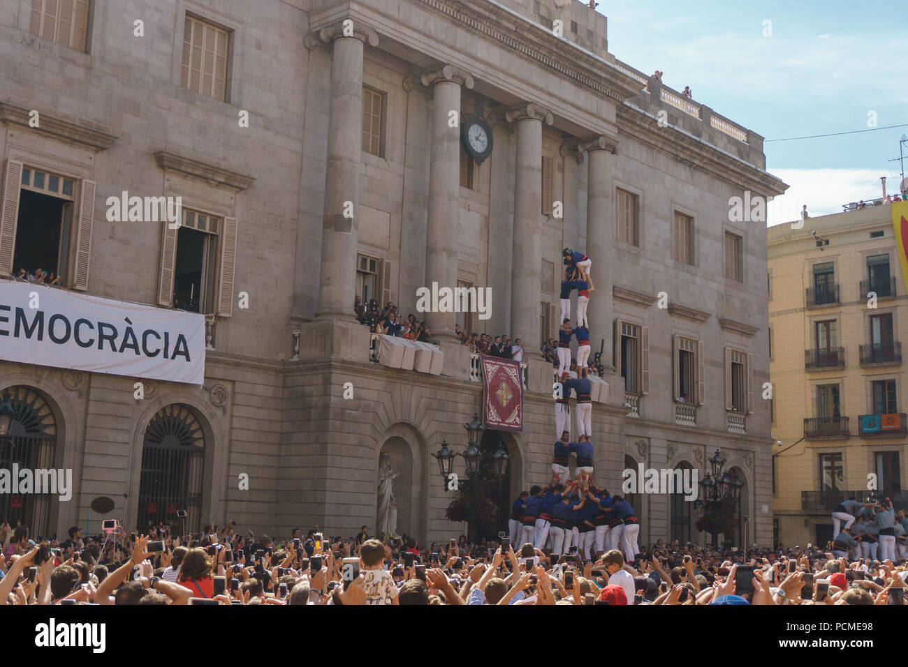 people building a human pyramid during the festival in catalunya, spain ...