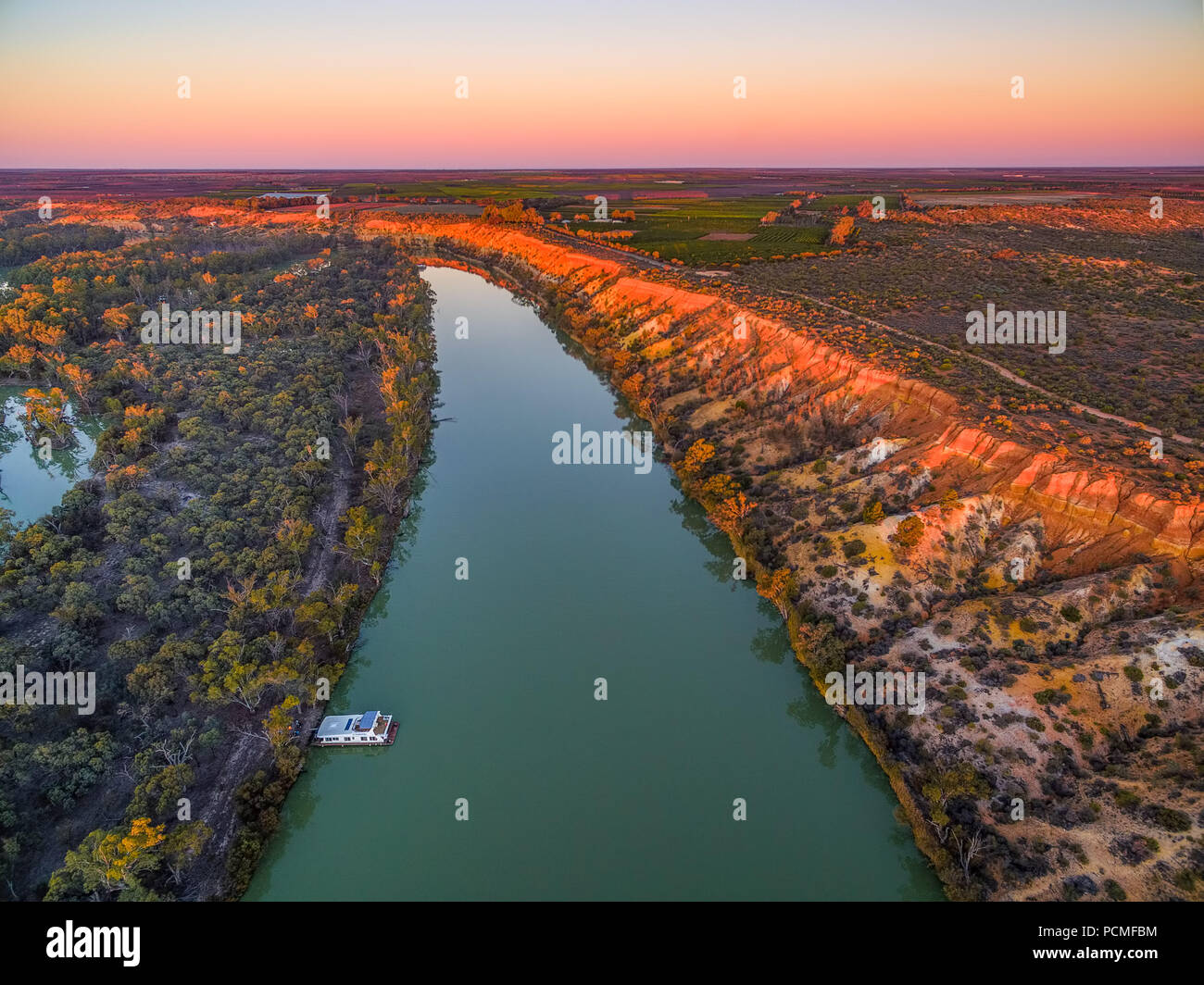 Aerial landscape of sandstone cliffs over Murray RIver and moored ...