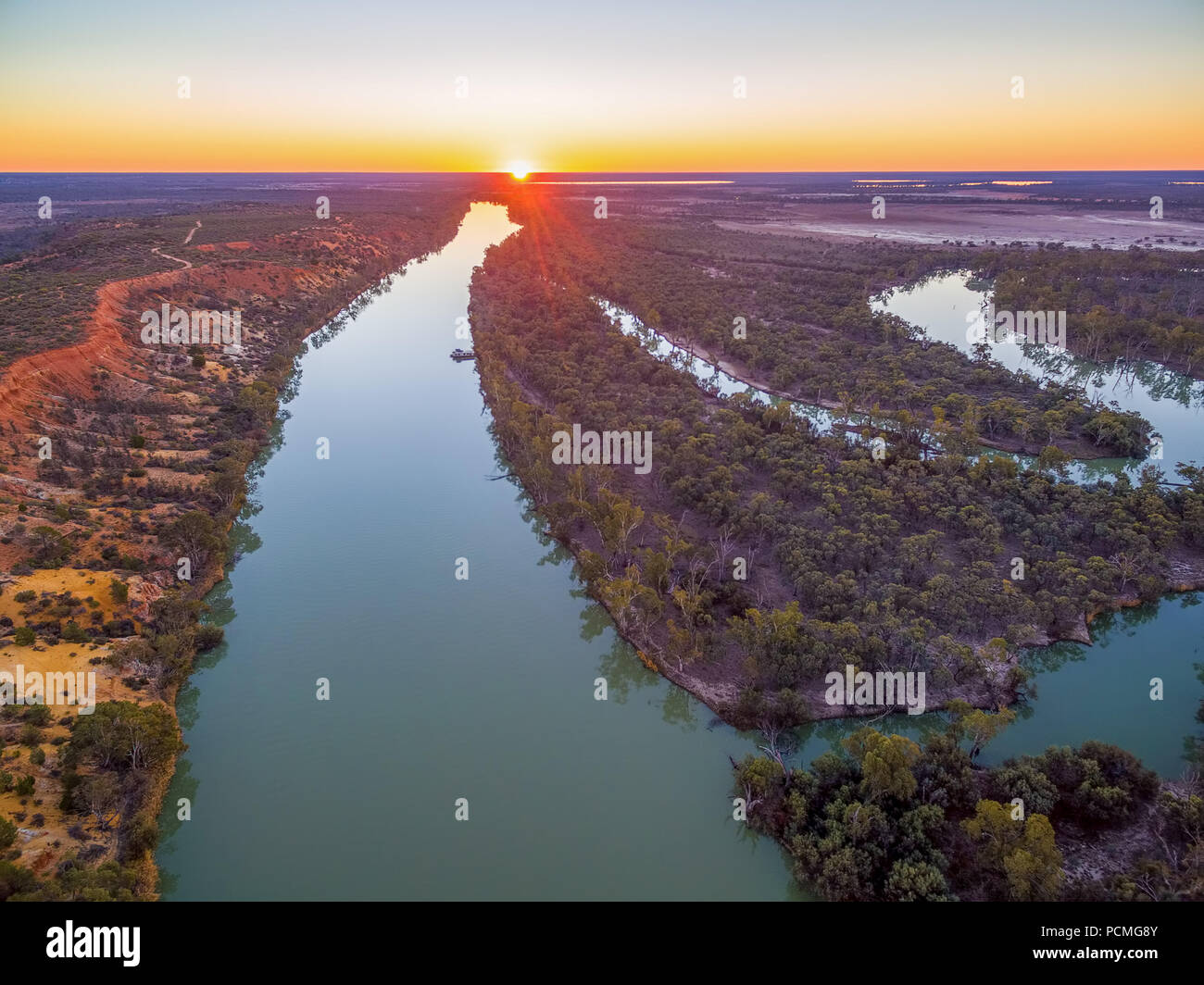 Murray River flowing to the horizon at beautiful sunset - aerial ...