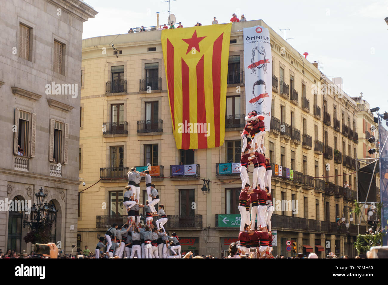 people building a human pyramid during the festival in catalunya, spain ...