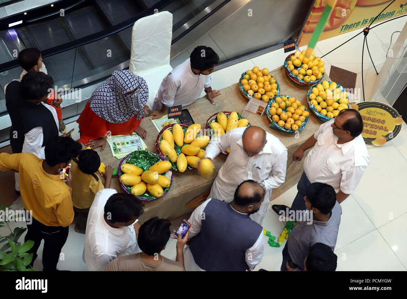 Islamabad. 3rd Aug, 2018. People visit a mango stall during mango ...