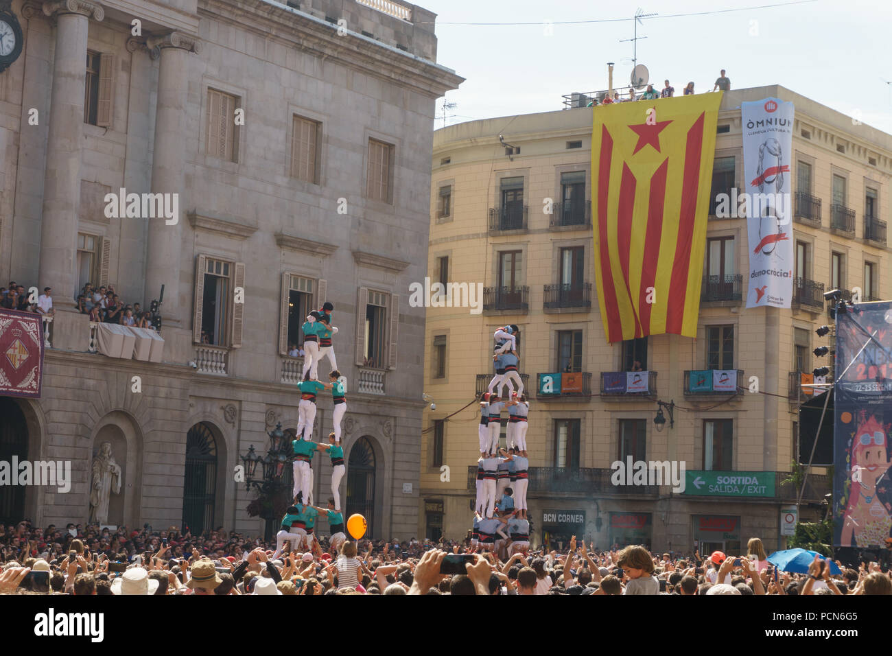 people building a human pyramid during the festival in catalunya, spain ...