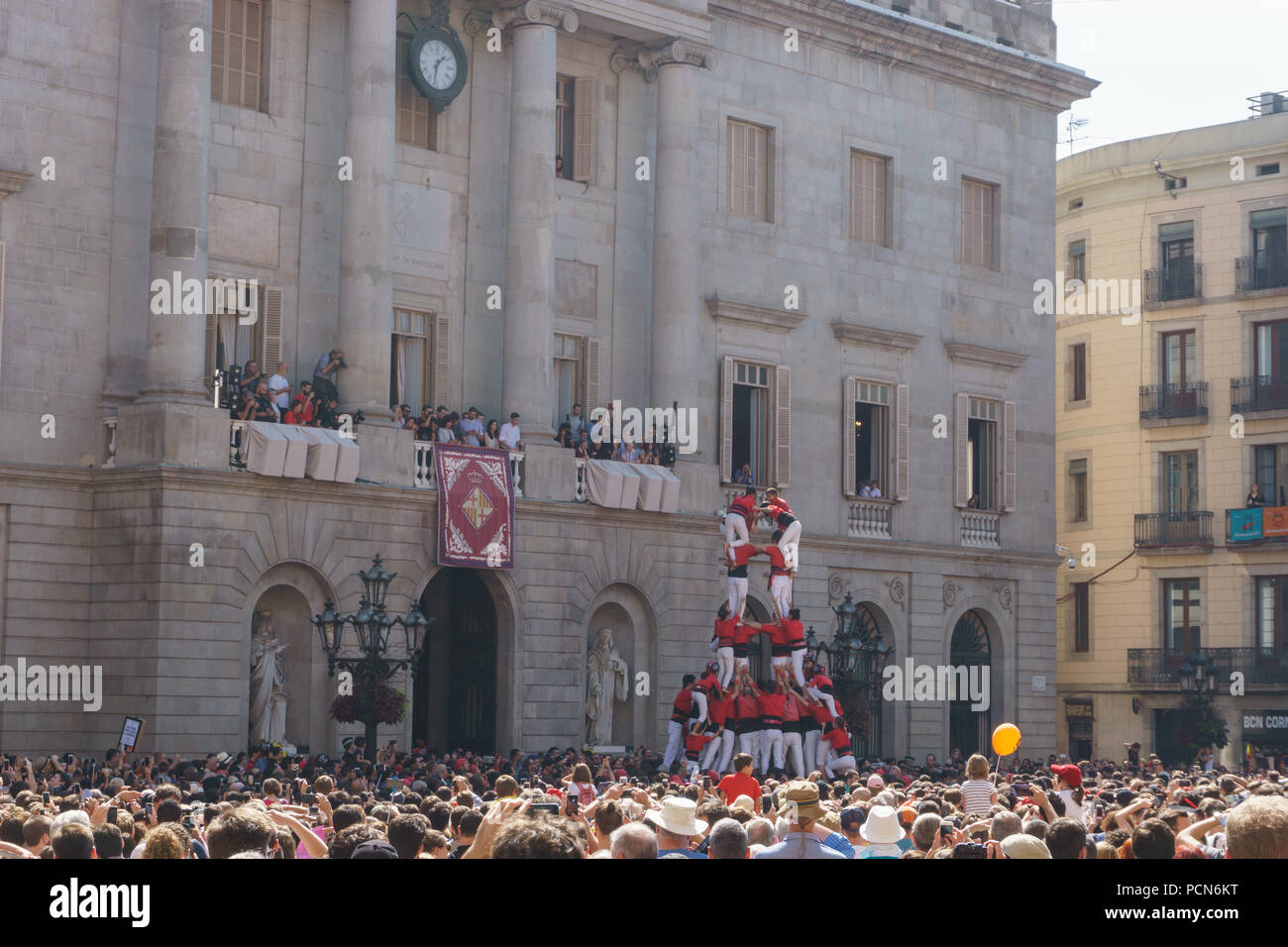 people building a human pyramid during the festival in catalunya, spain ...