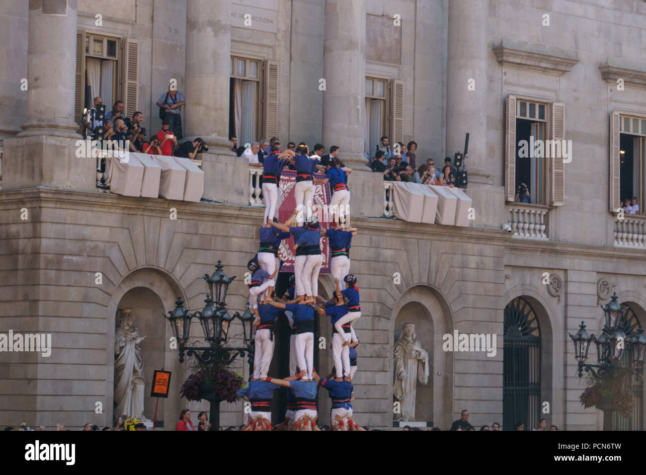 people building a human pyramid during the festival in catalunya, spain ...