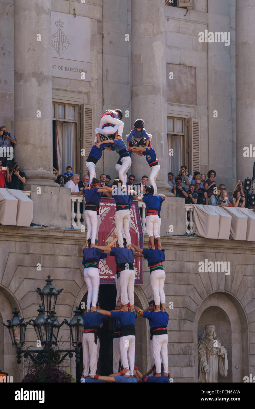 people building a human pyramid during the festival in catalunya, spain ...