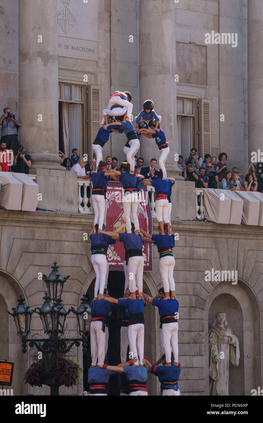 people building a human pyramid during the festival in catalunya, spain ...