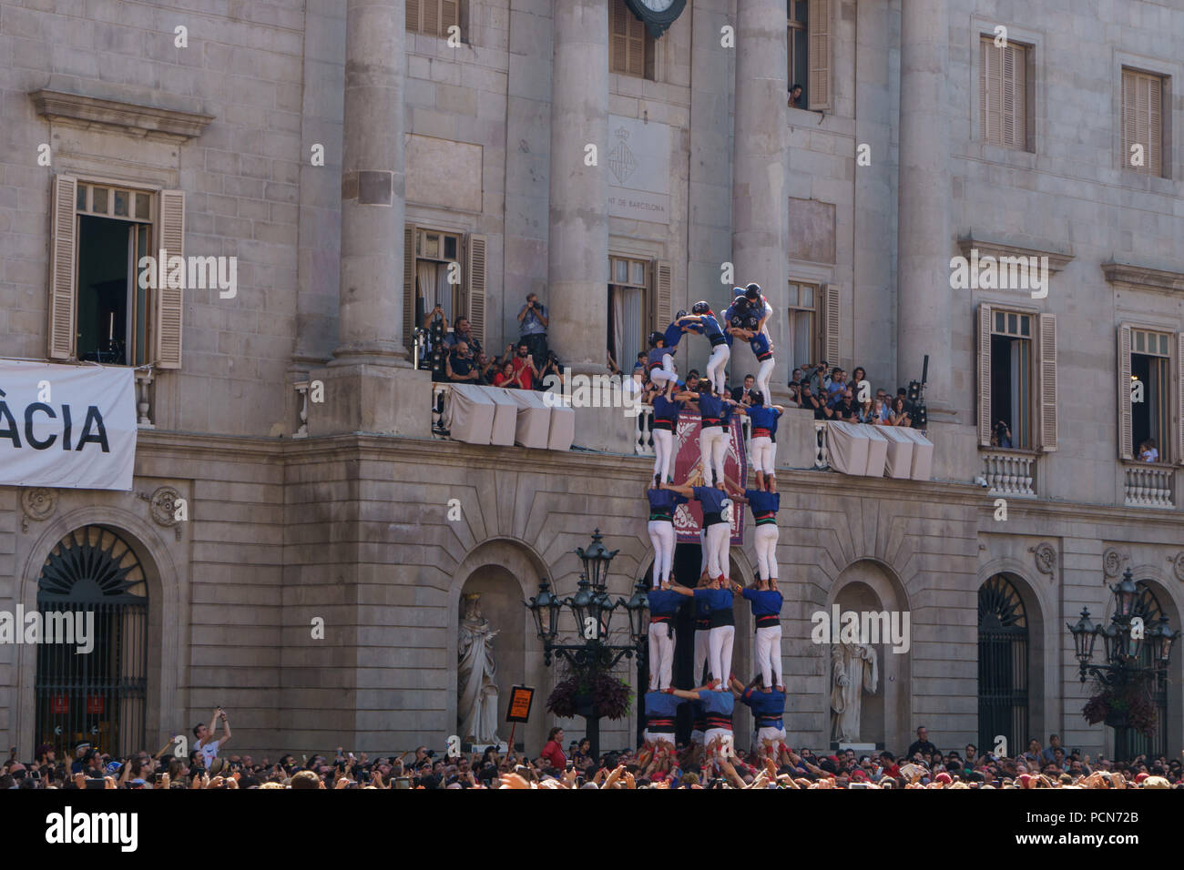 people building a human pyramid during the festival in catalunya, spain ...