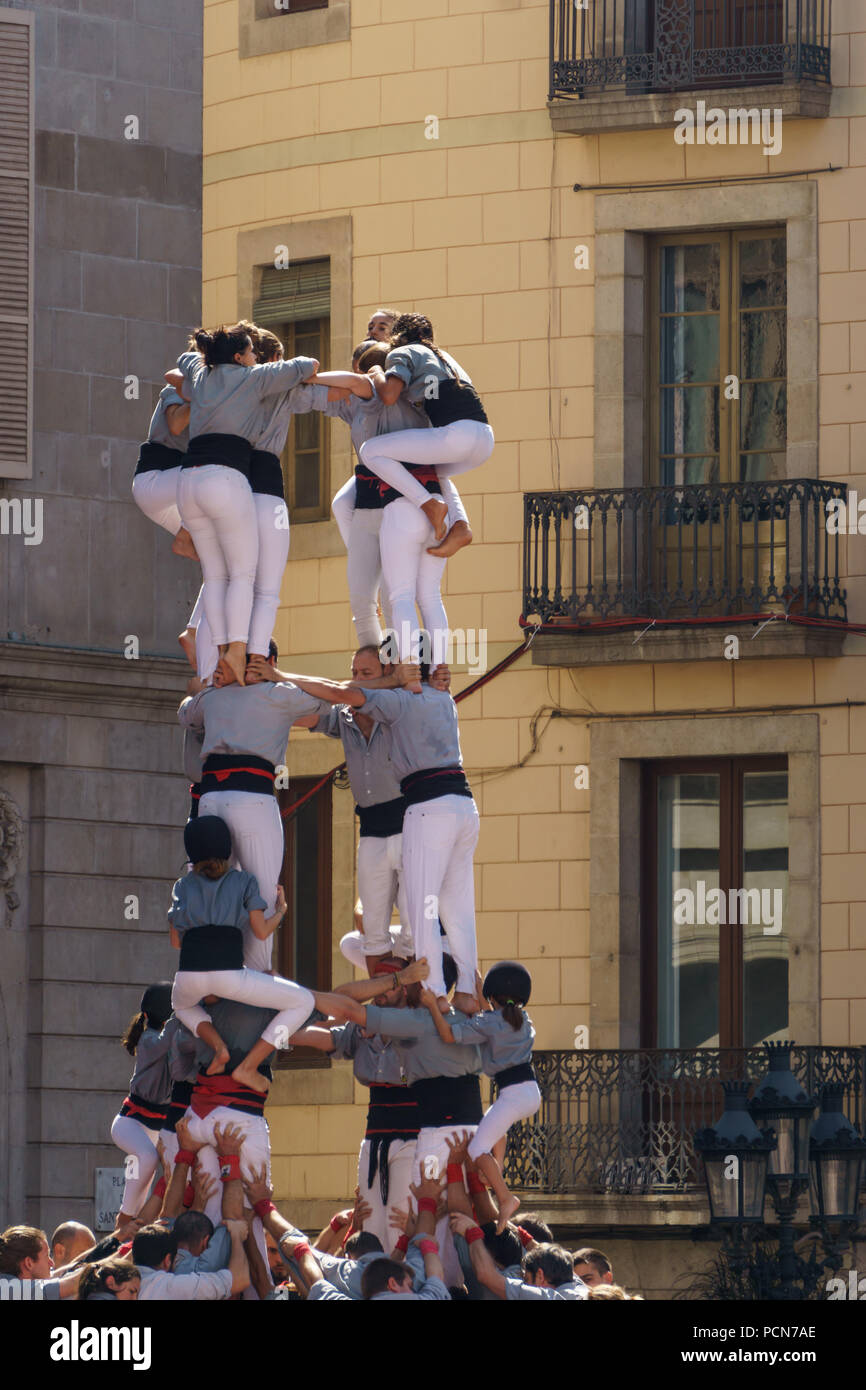 people building a human pyramid during the festival in catalunya, spain ...