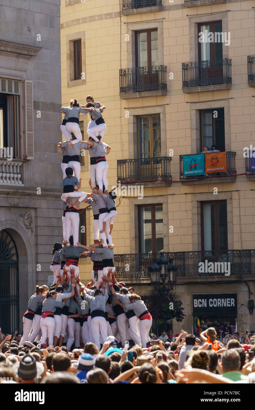people building a human pyramid during the festival in catalunya, spain ...