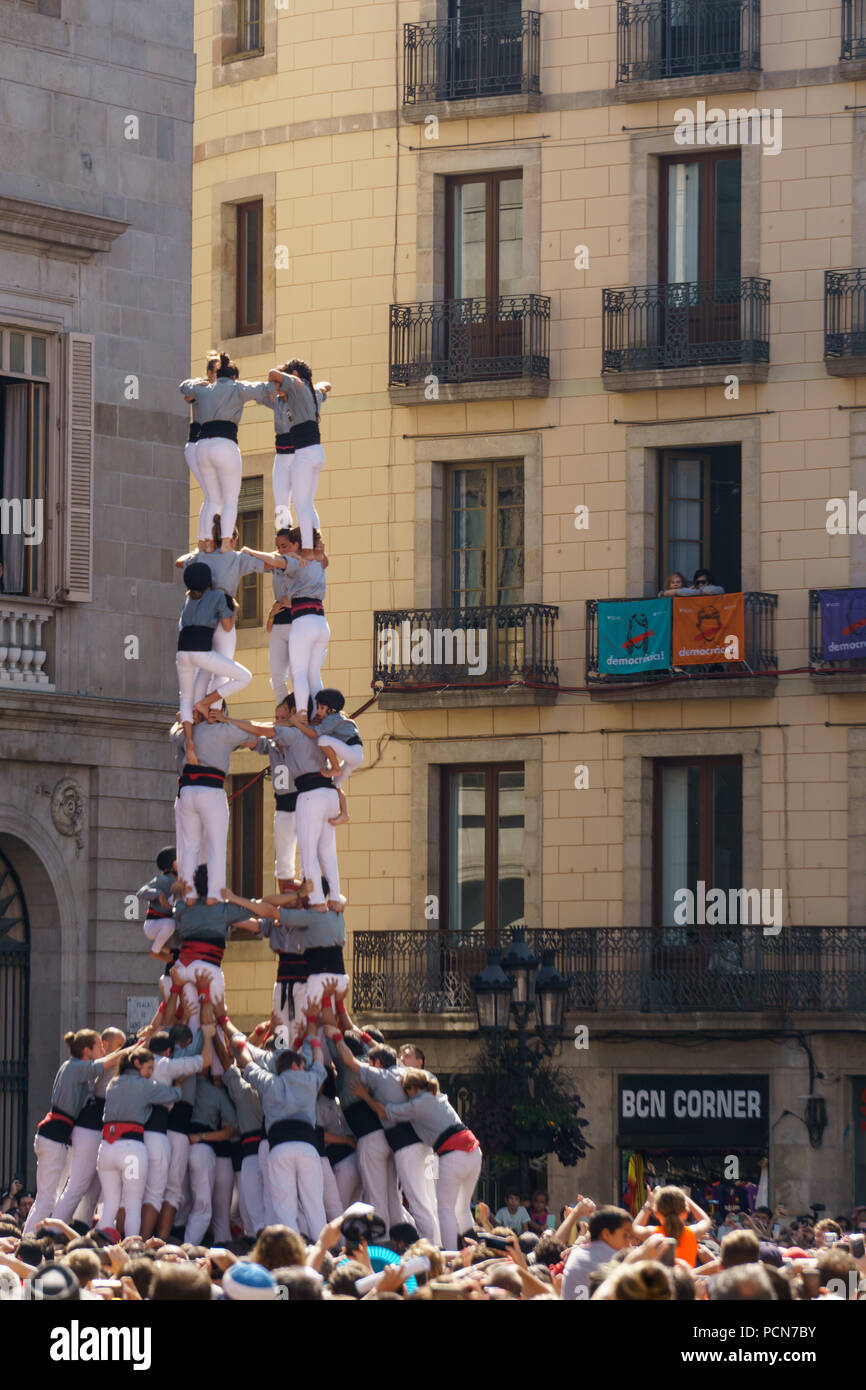 people building a human pyramid during the festival in catalunya, spain ...