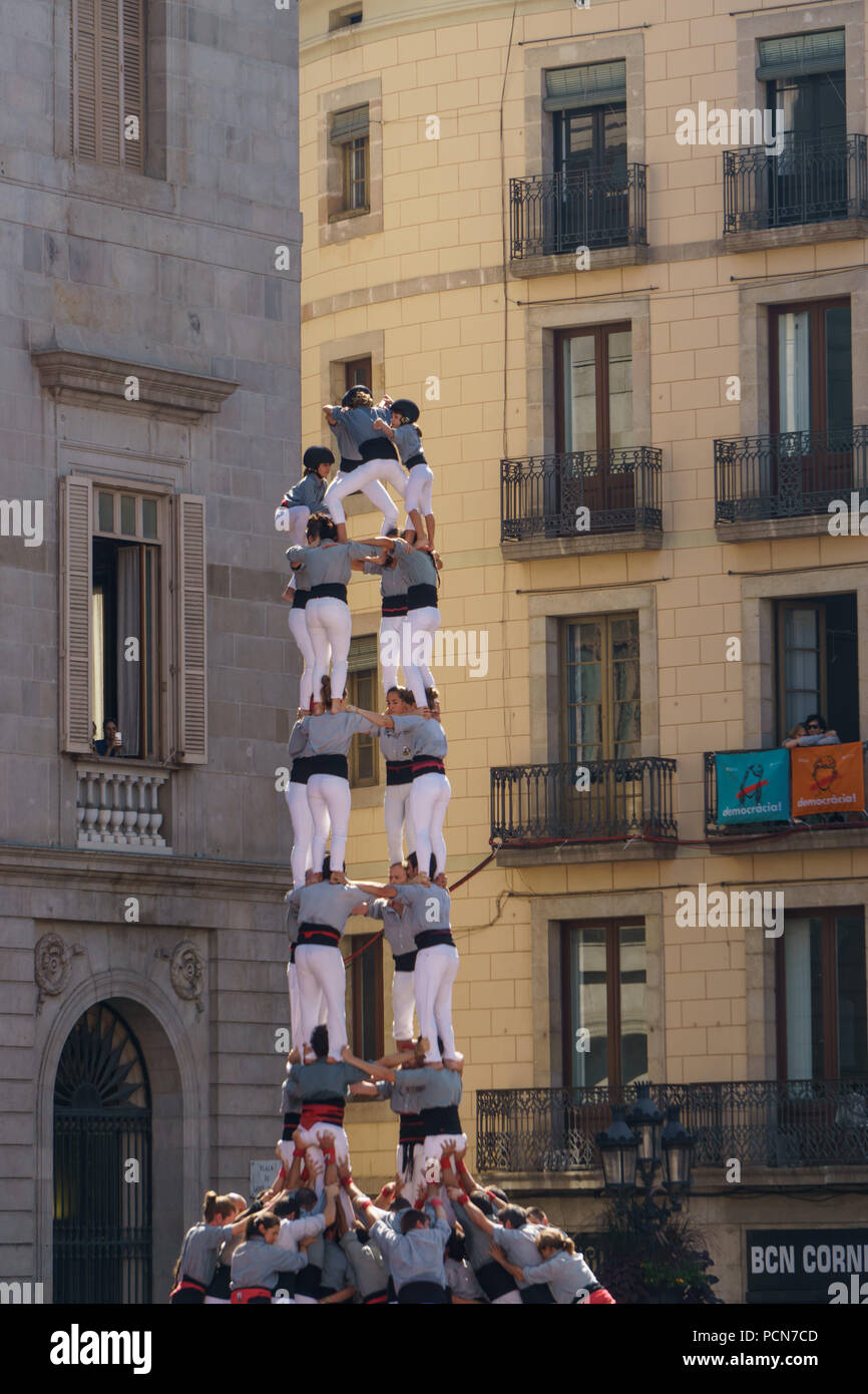 people building a human pyramid during the festival in catalunya, spain ...
