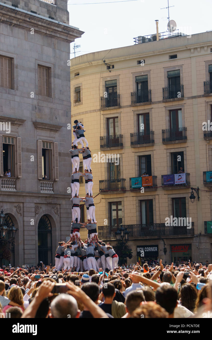 people building a human pyramid during the festival in catalunya, spain ...
