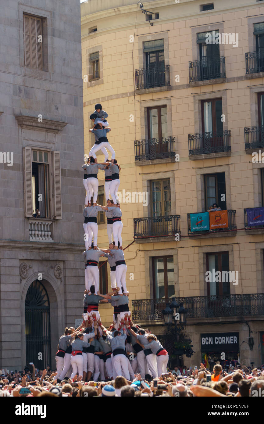 people building a human pyramid during the festival in catalunya, spain ...