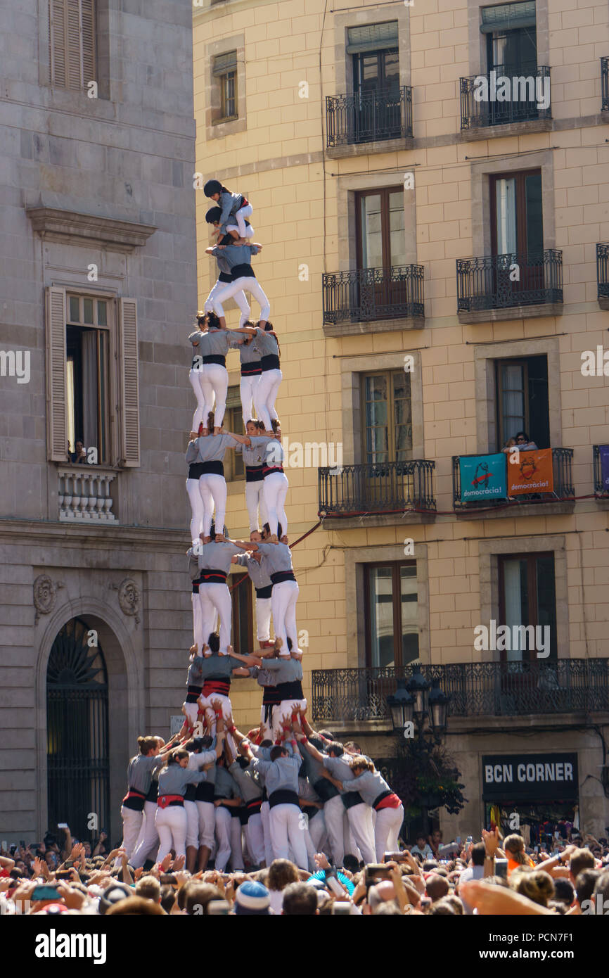 people building a human pyramid during the festival in catalunya, spain ...