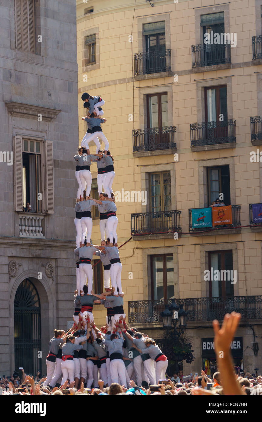 people building a human pyramid during the festival in catalunya, spain ...