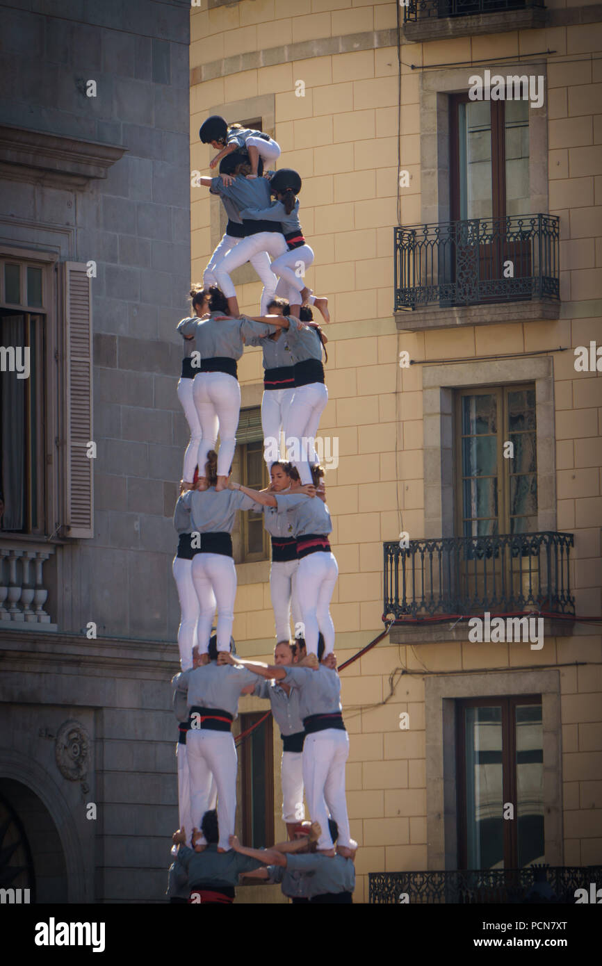 people building a human pyramid during the festival in catalunya, spain ...