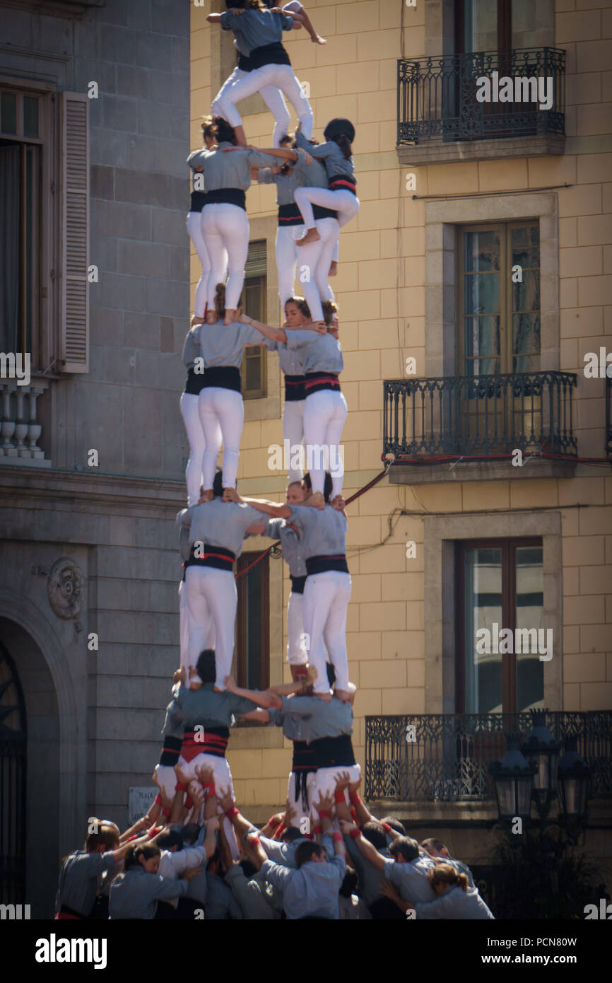 people building a human pyramid during the festival in catalunya, spain ...