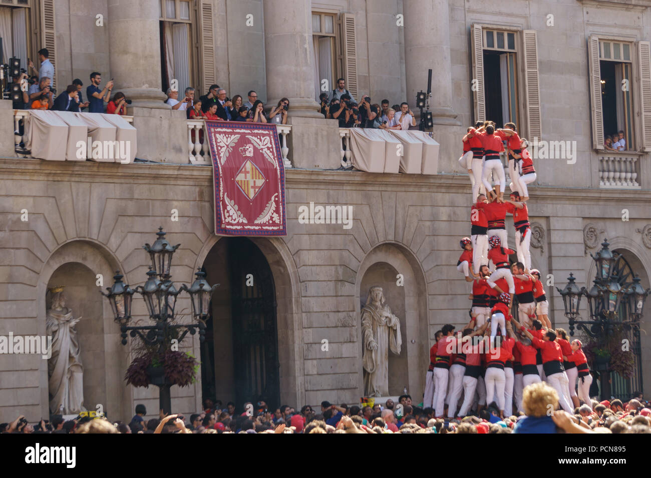 people building a human pyramid during the festival in catalunya, spain ...