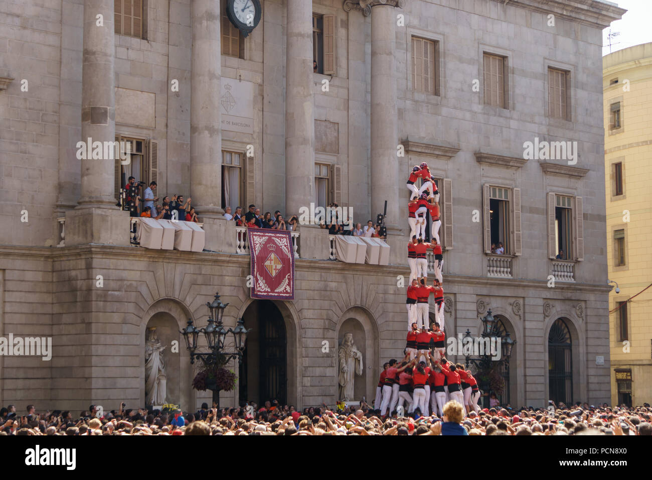 people building a human pyramid during the festival in catalunya, spain ...