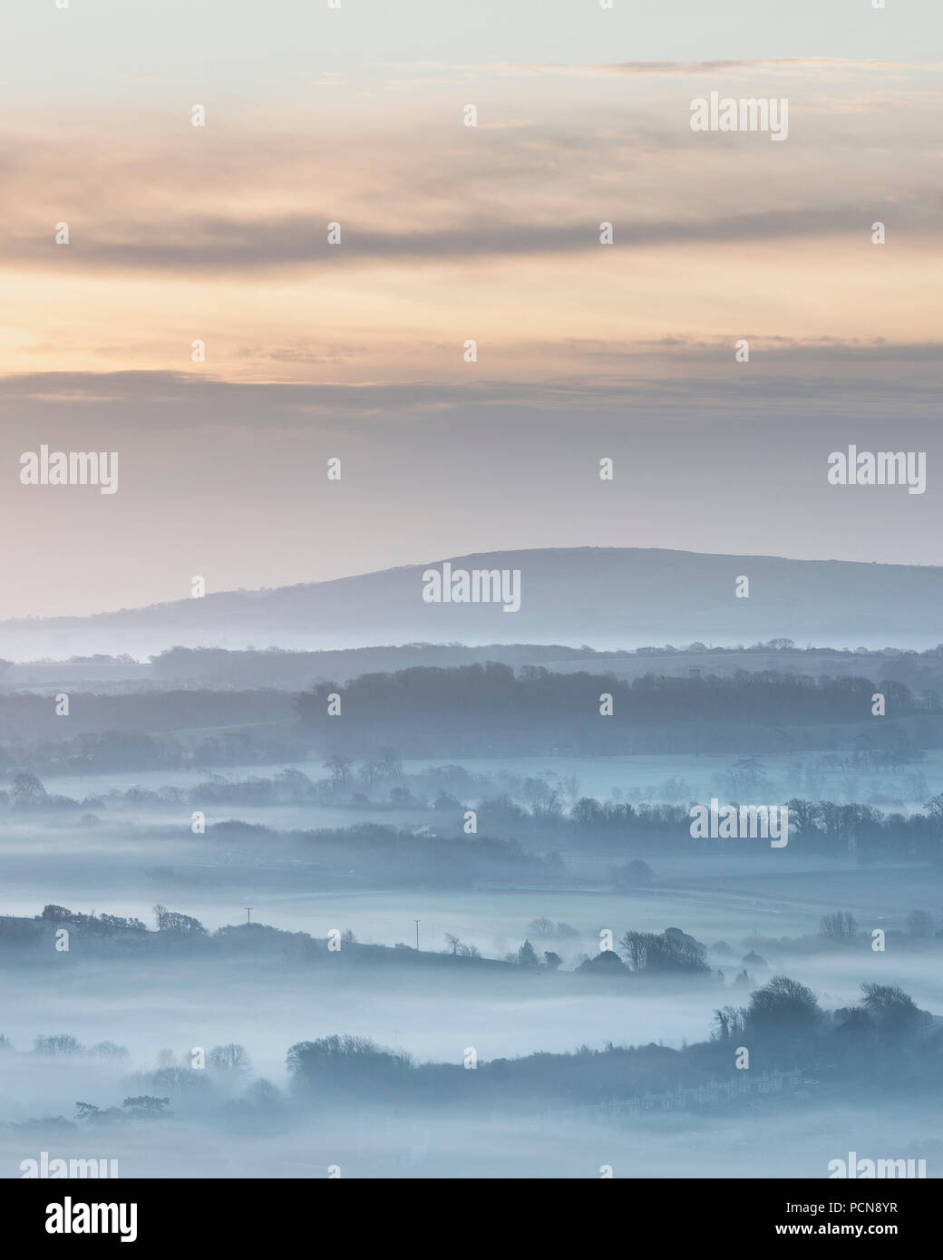 Beautiful foggy English countryside landscape at sunrise in Winter with ...