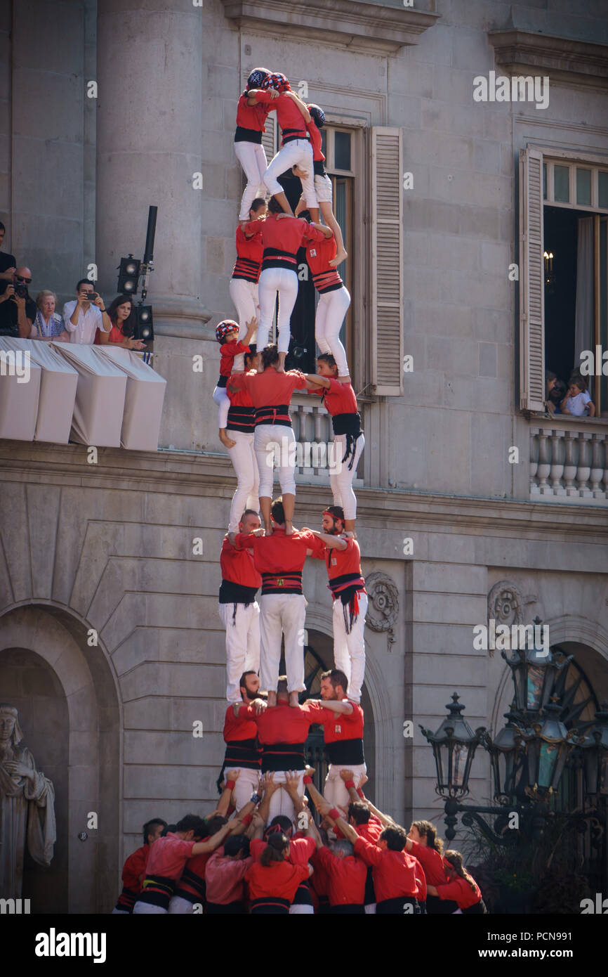 people building a human pyramid during the festival in catalunya, spain ...