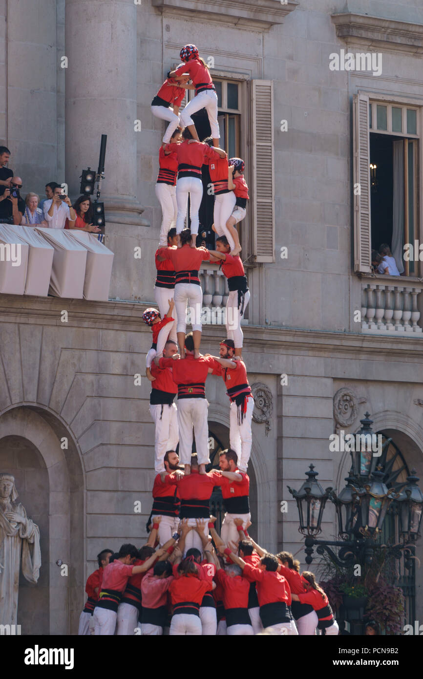 people building a human pyramid during the festival in catalunya, spain ...