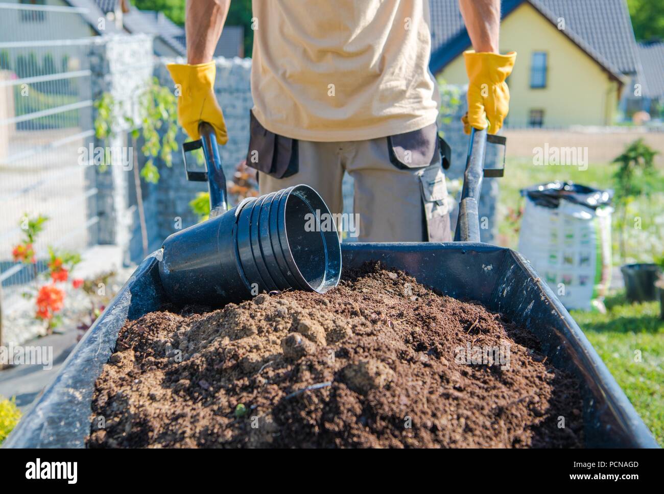 Caucasian Men Building Garden by Moving Soil in the Barrow. Gardening ...