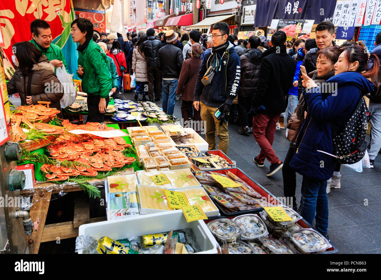 Kuromon Ichiba, Osaka's kitchen food market. Seafood stall with two ...