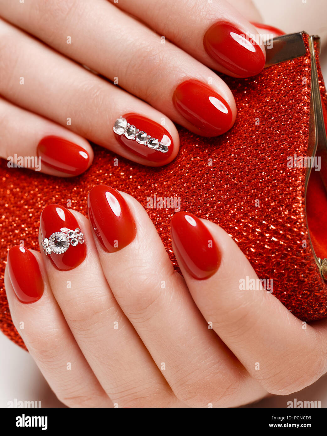 Bright festive red manicure Stock Photo - Alamy