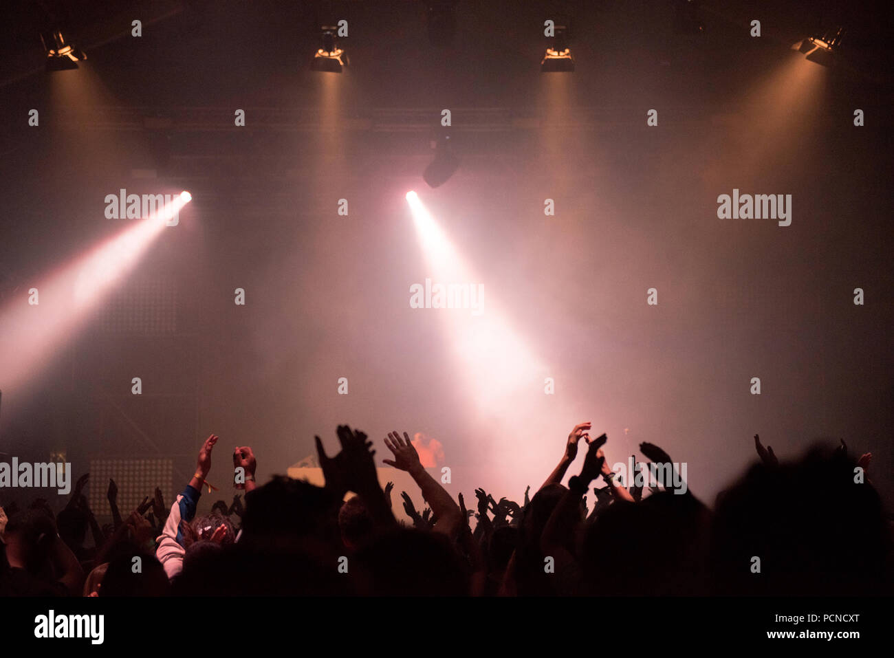 Crowd of people clapping their hands at concert. Stage lights Stock ...