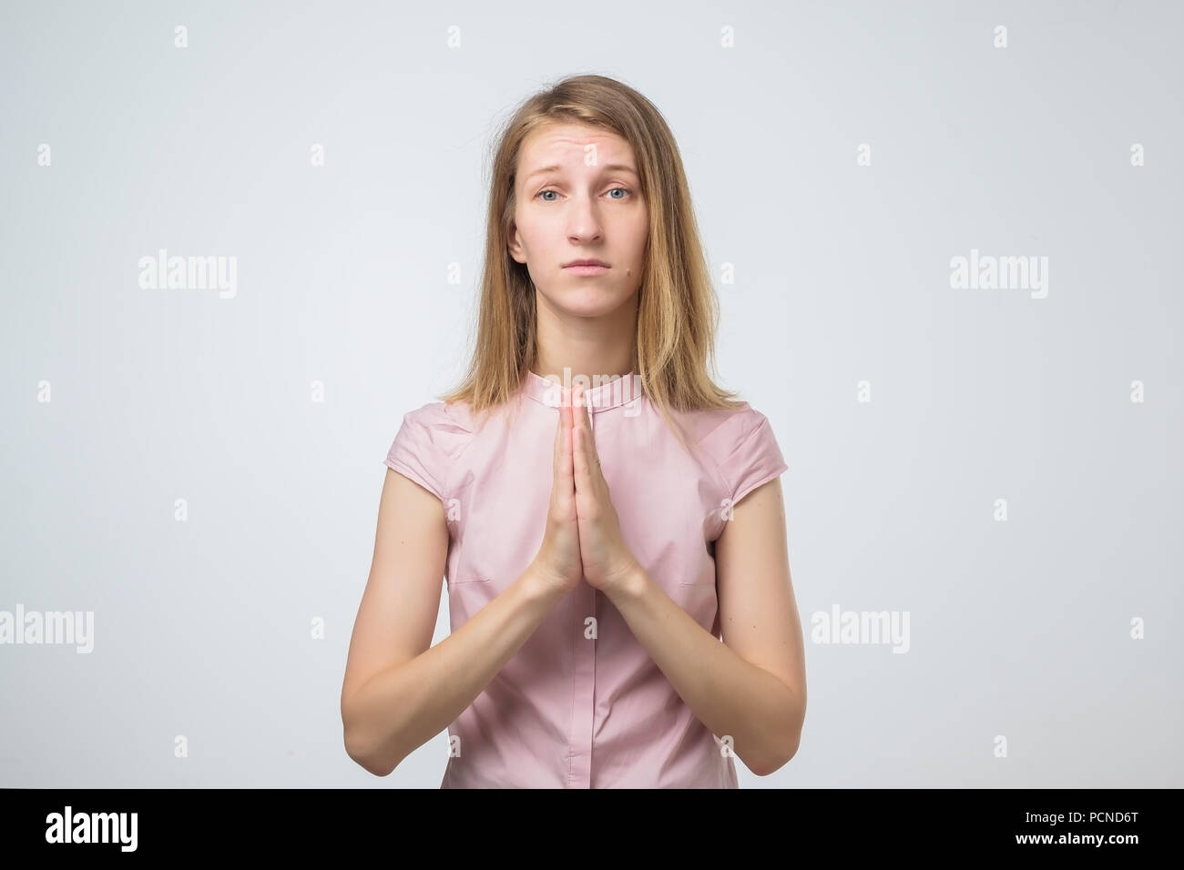 Closeup portrait of a sad young woman praying, hoping, begging for the ...