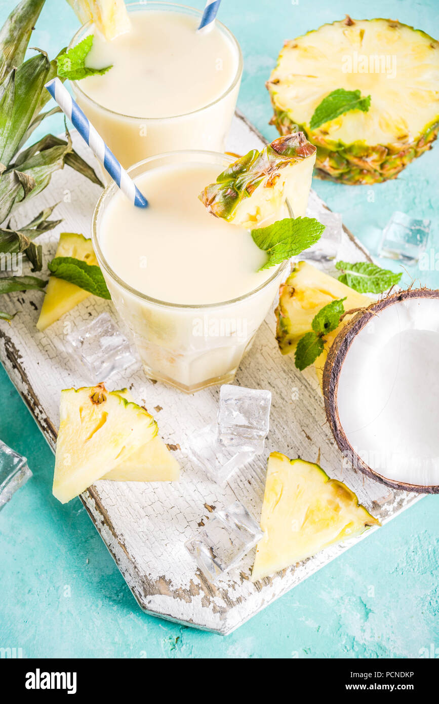 Refreshing summer drink, homemade pina colada cocktail, on a light blue ...