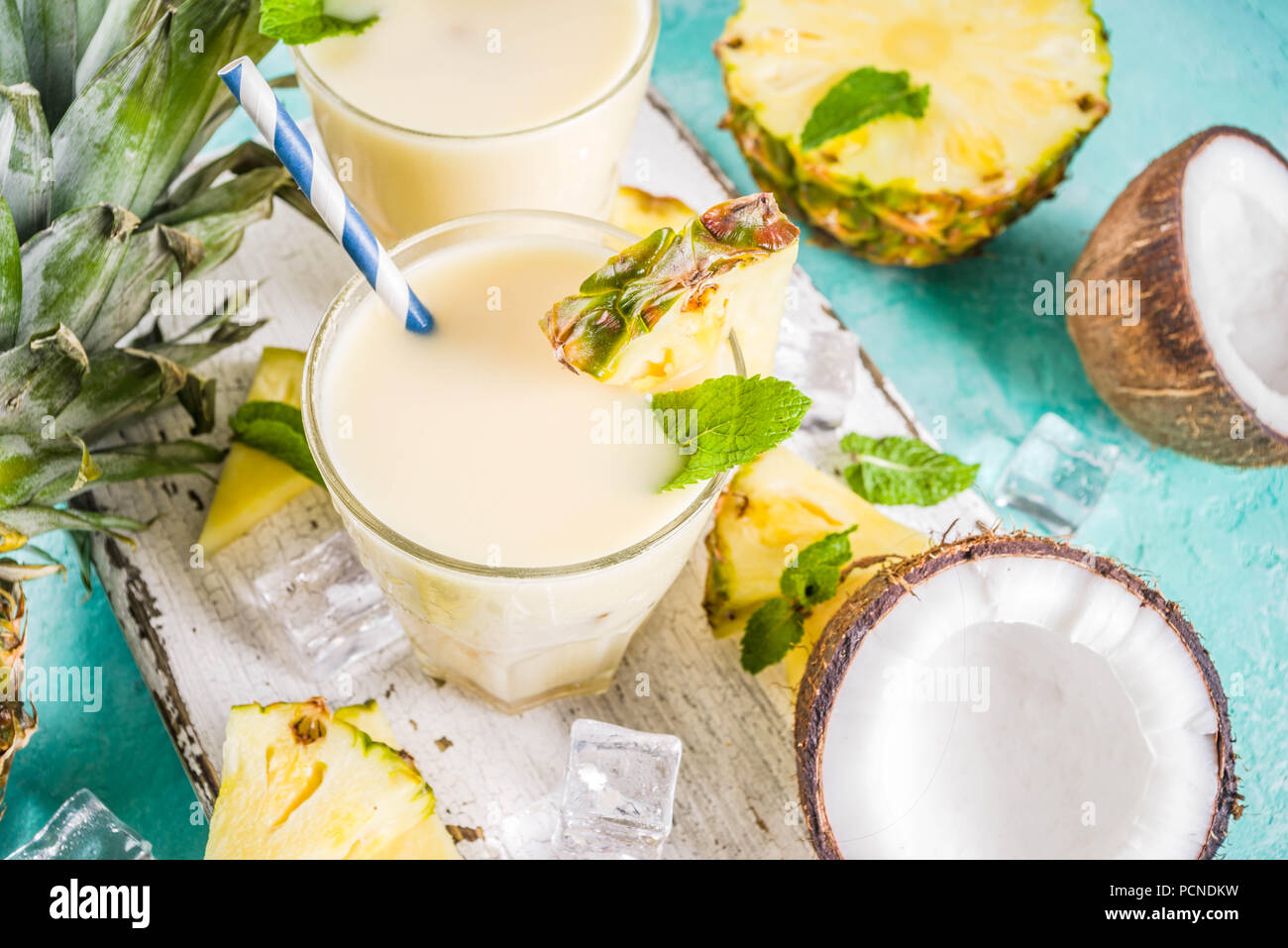 Refreshing summer drink, homemade pina colada cocktail, on a light blue ...
